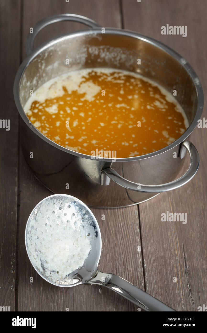 Melted butter in pot beside strainer hi-res stock photography and ...