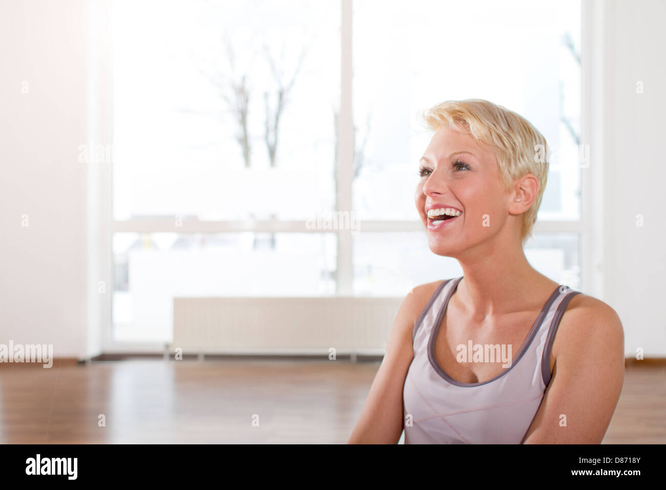Germany, Brandenburg, Woman laughing in gym Stock Photo - Alamy