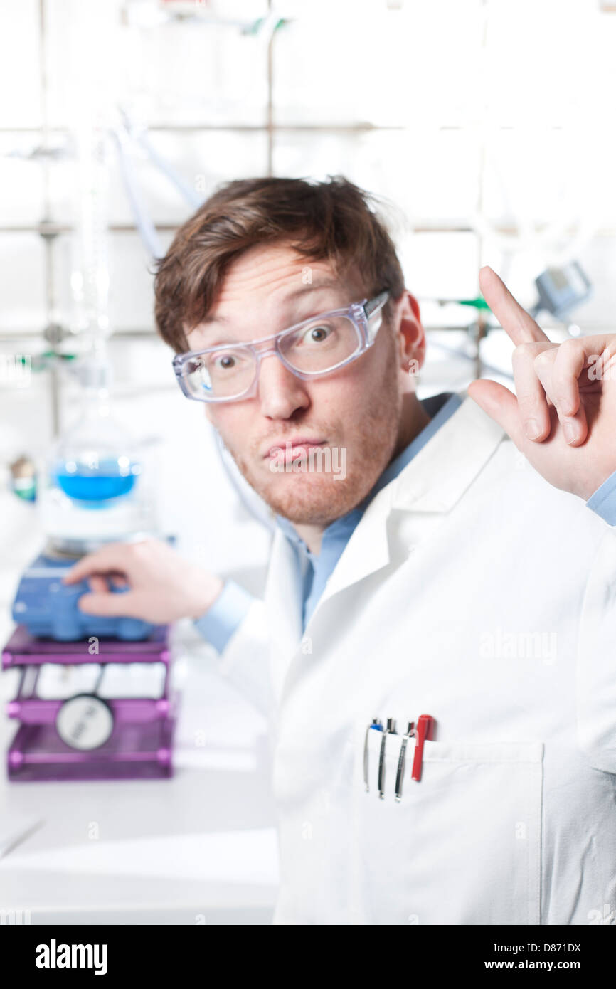 Germany, Portrait of young scientist explaining chemical process ...