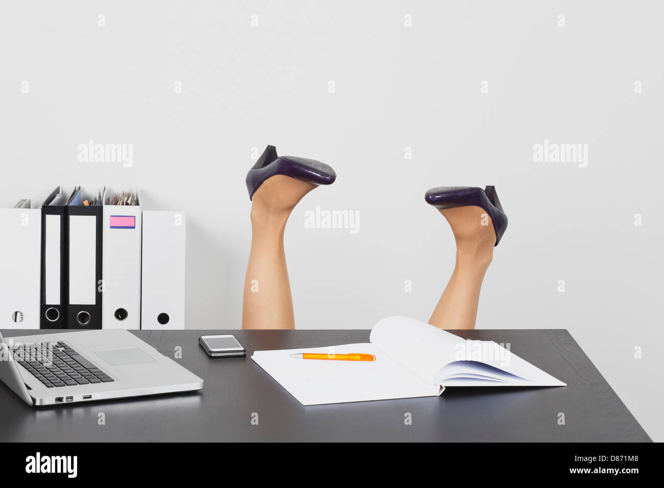 Business woman overturning behind office desk Stock Photo - Alamy