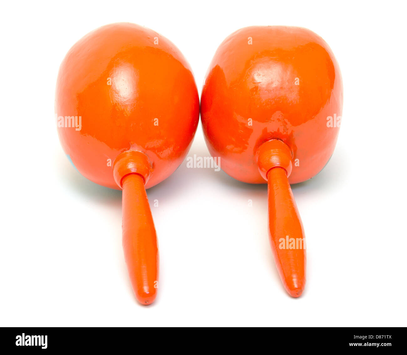 Orange maracas on white background Stock Photo - Alamy