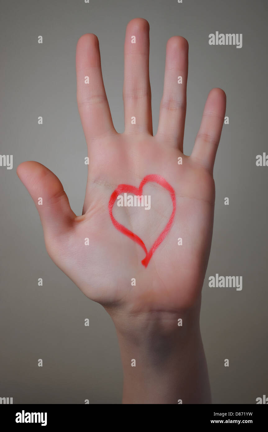 Red Heart Shape on a Hand Stock Photo - Alamy