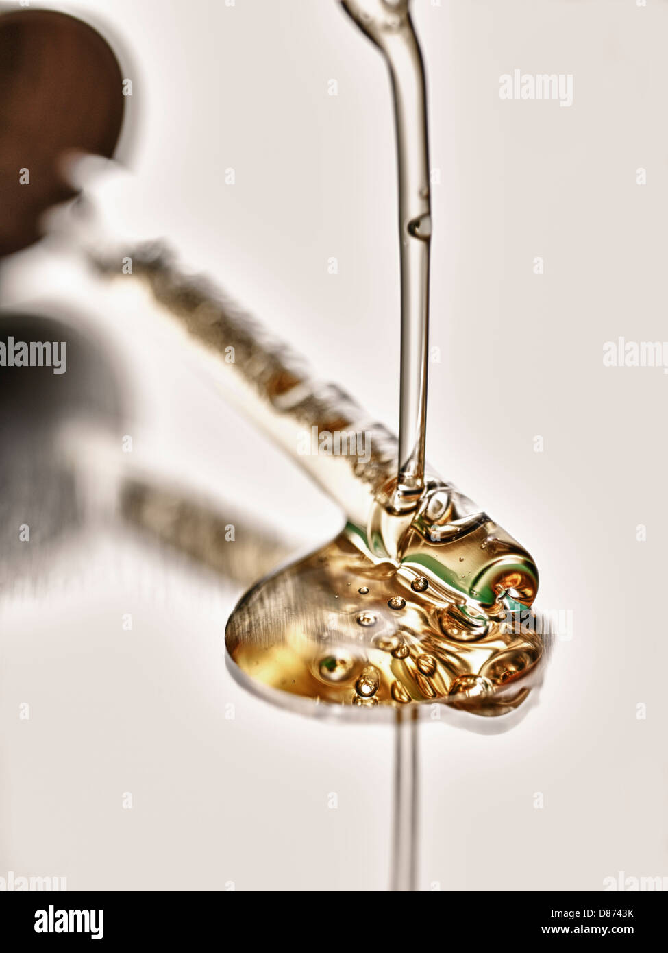 Cosmetics oil being poured on pipette, close up Stock Photo - Alamy