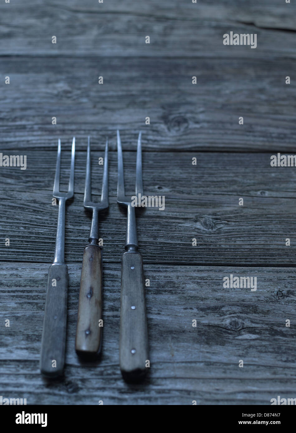 Old fashioned forks on wooden table, close up Stock Photo - Alamy