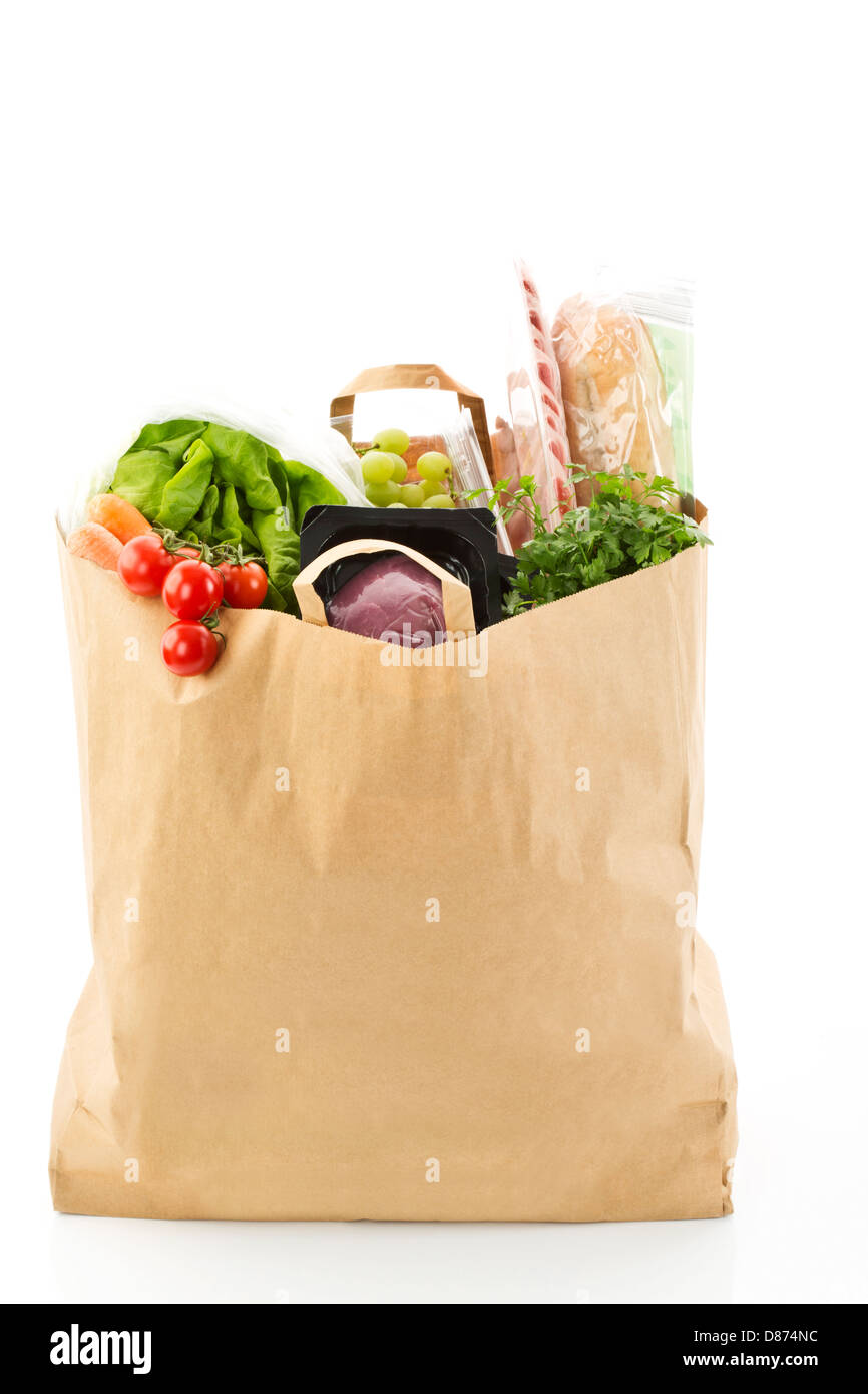 Groceries in paper bag on white background, close up Stock Photo - Alamy