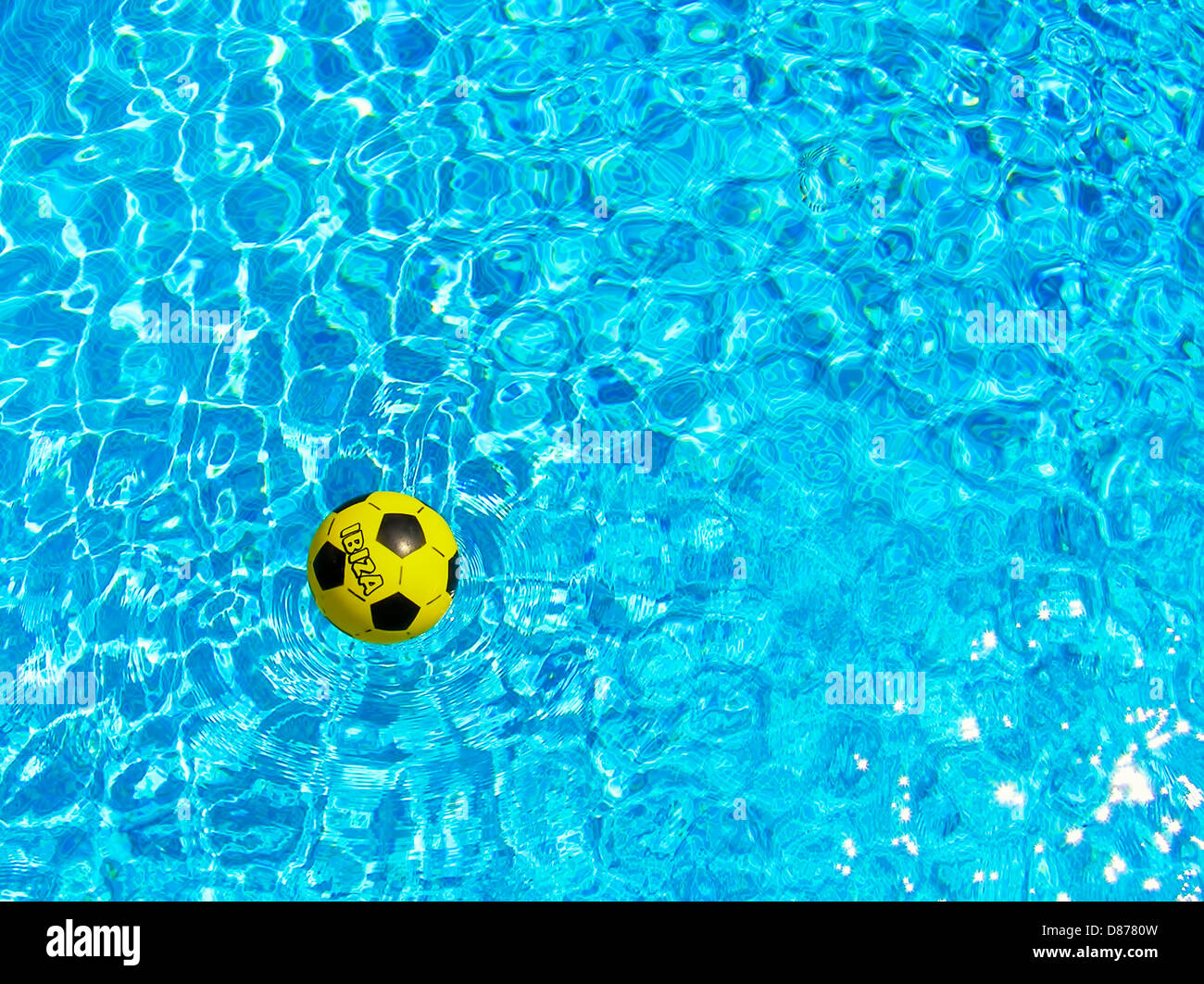 Spain, Football floating on water in pool Stock Photo - Alamy