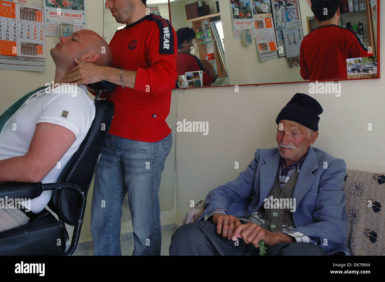 Barber shaving and grooming men in Turkish village barber shop Stock ...