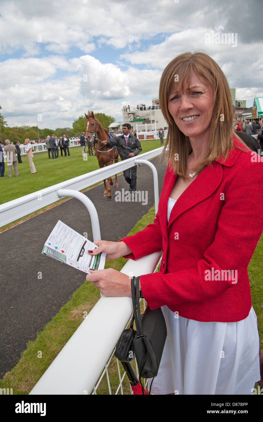 Race goer in the parade ring of a race course holding a racecard Stock ...