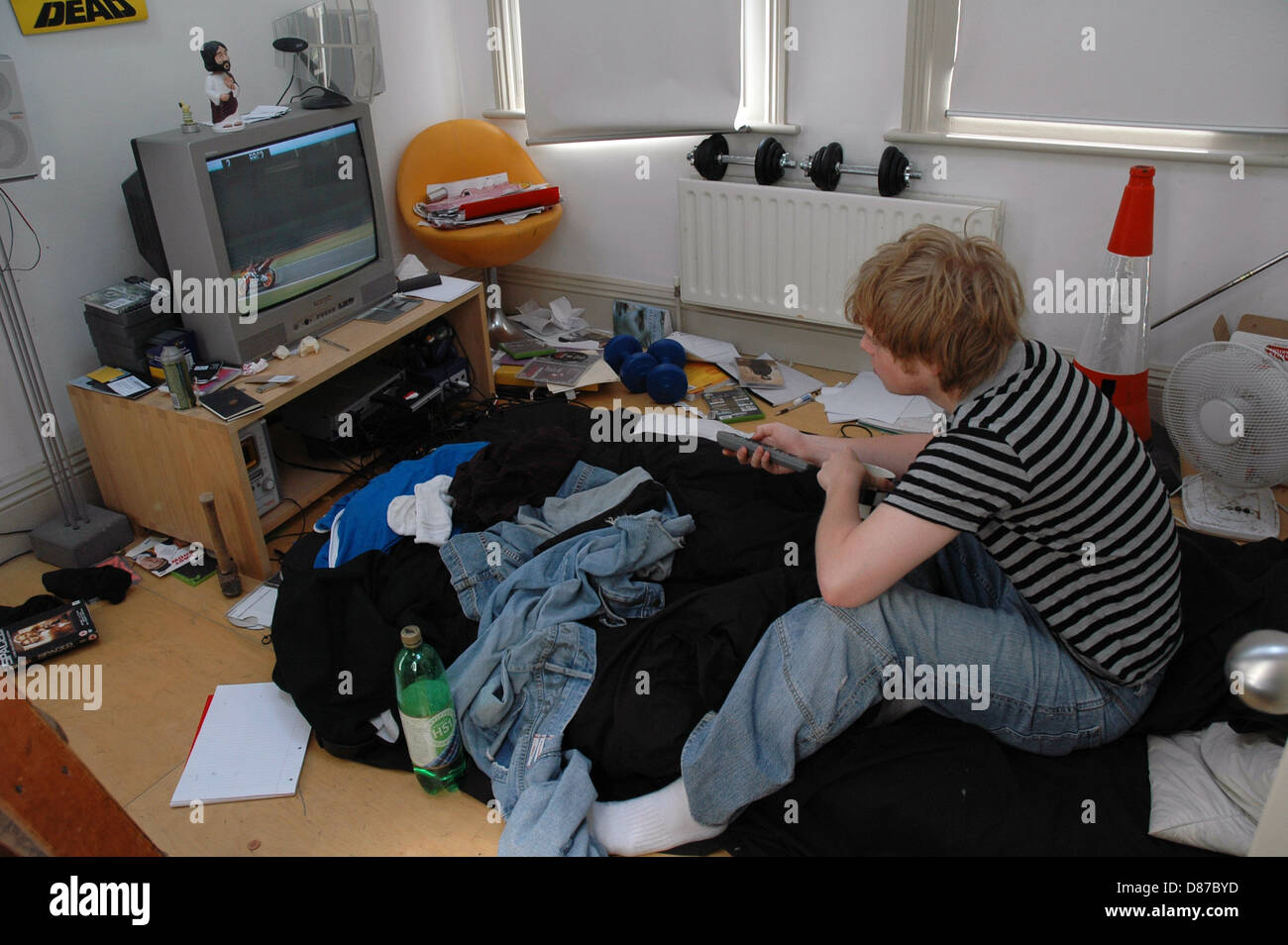 Young teenage student on his bed watching television Stock Photo - Alamy