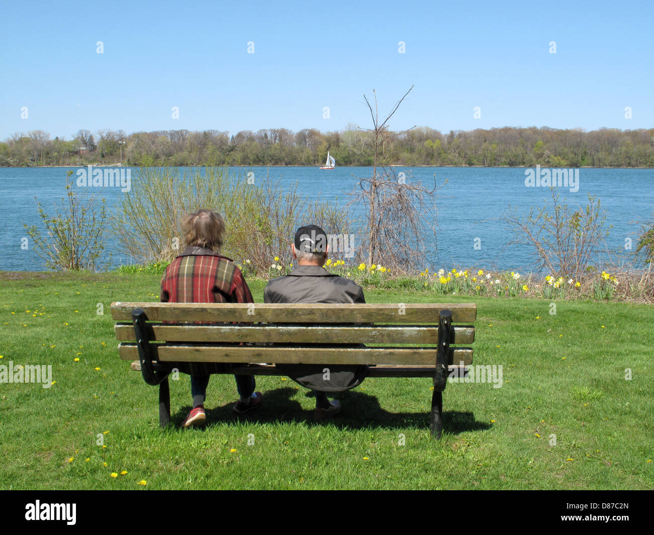 Man sitting on a bench at the riverside hi-res stock photography and ...