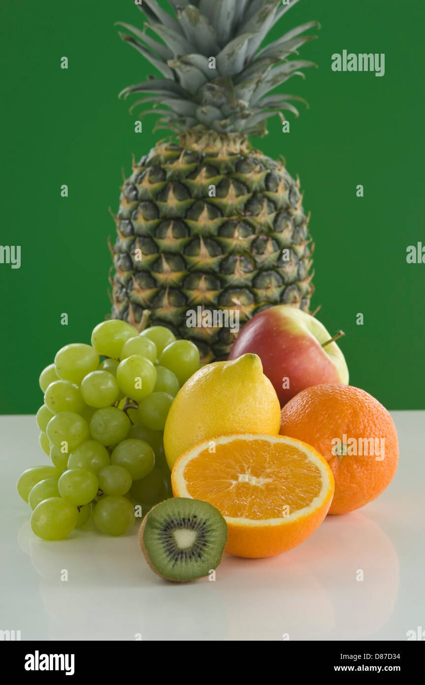 Variety of fruits against green background, close up Stock Photo - Alamy