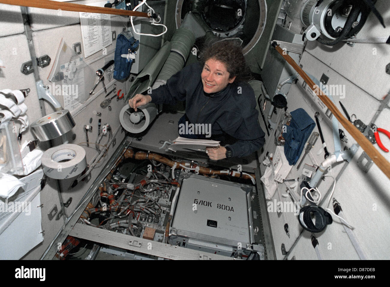 NASA astronaut Susan J. Helms performs battery maintenance inside the ...