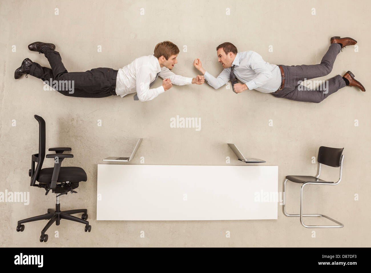 Businessmen fighting in office Stock Photo - Alamy