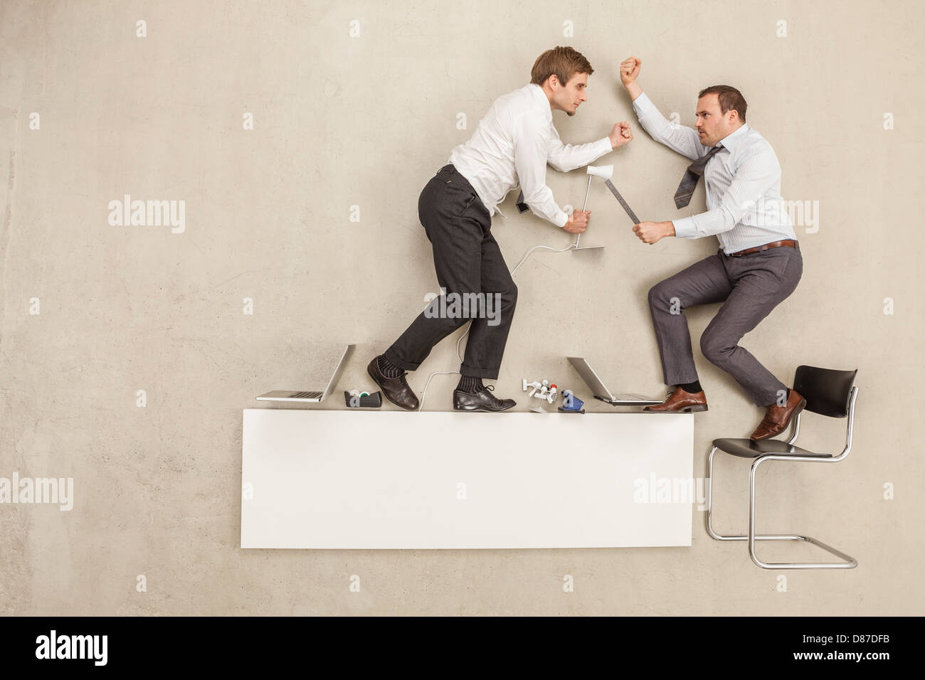 Businessmen fighting in office Stock Photo - Alamy