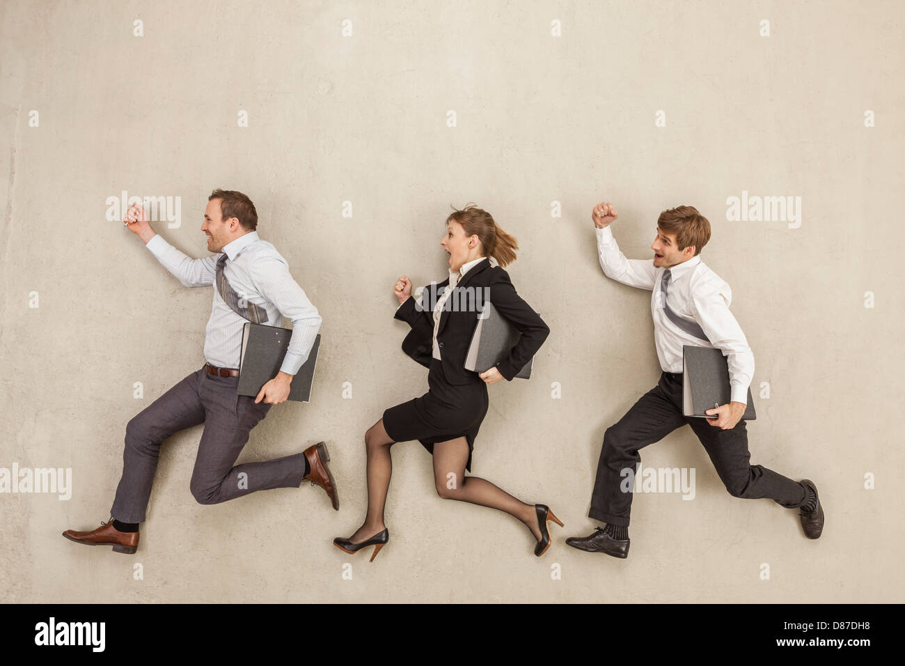 Business people with files running behind each other Stock Photo - Alamy