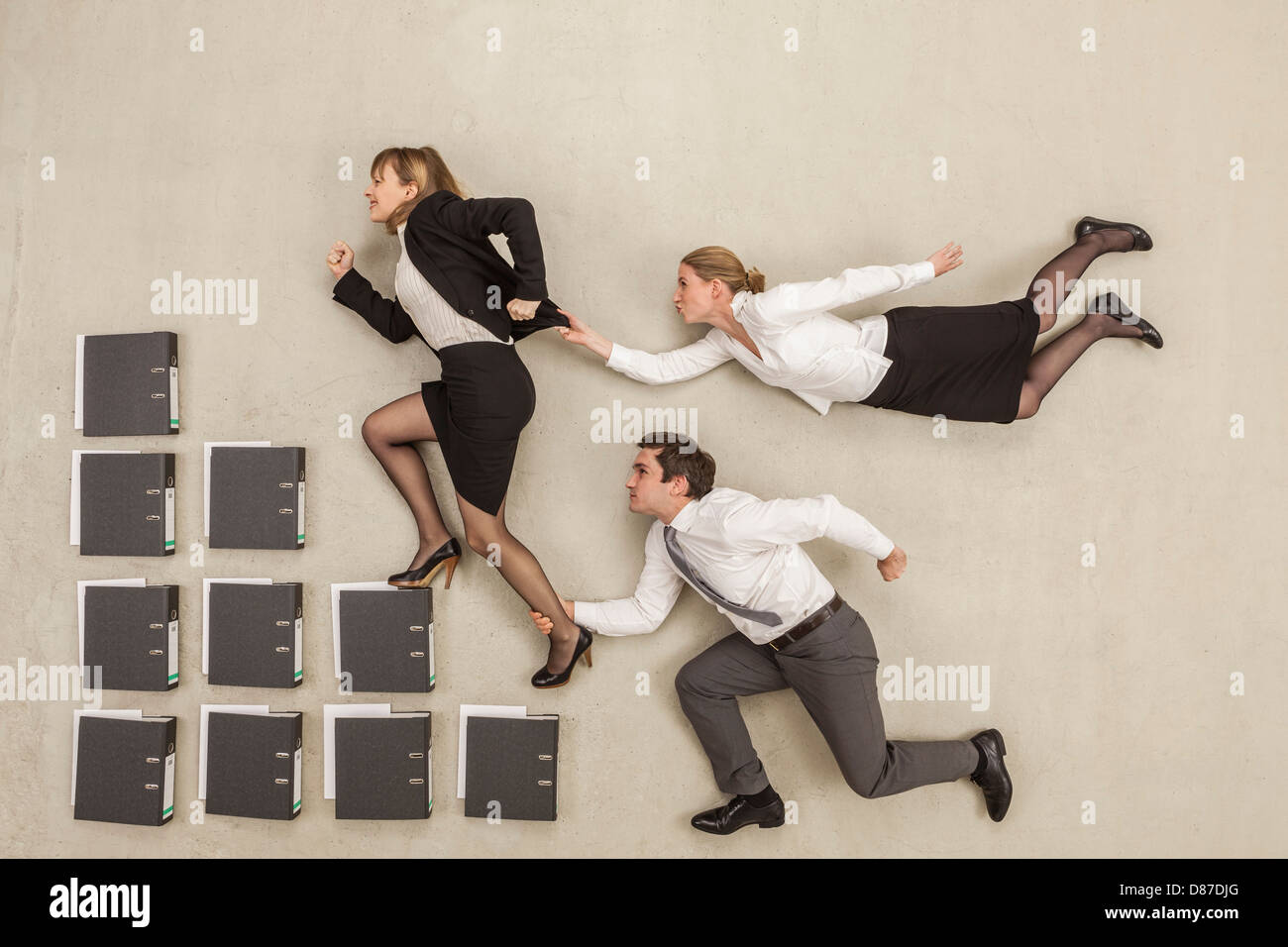 Businesswoman on staircase of files while others chasing Stock Photo ...