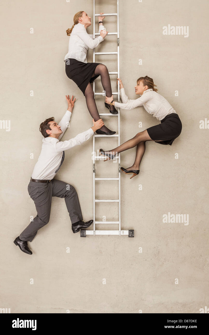 Business people climbing ladder in office Stock Photo - Alamy