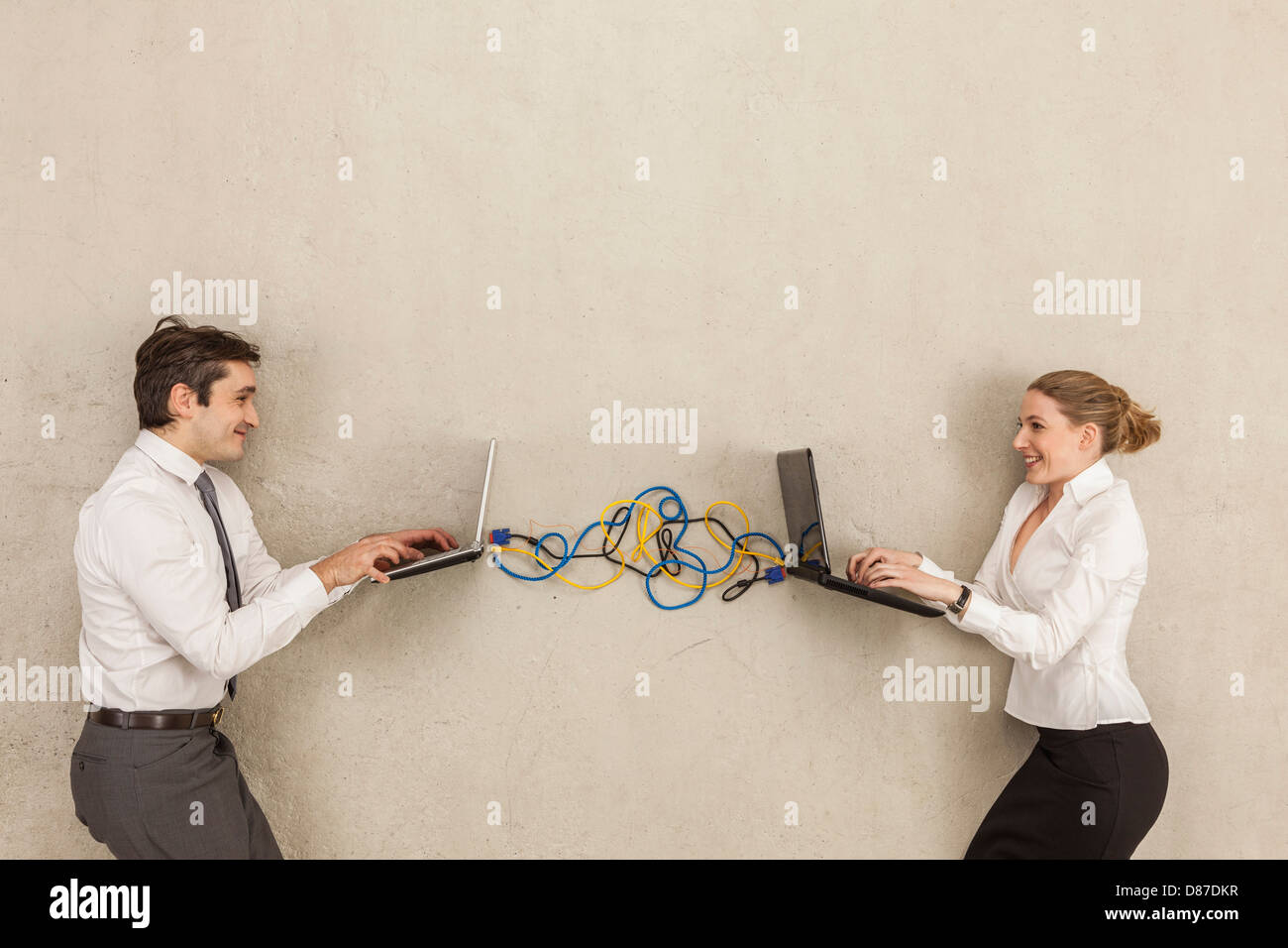 Business people using laptops connected with wires Stock Photo - Alamy