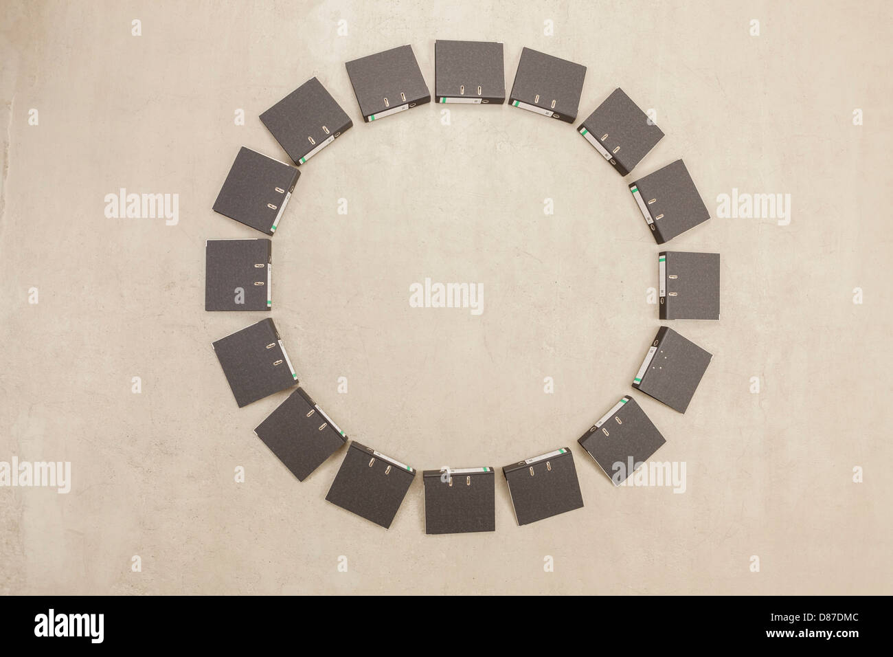 Files forming circle on beige background Stock Photo - Alamy