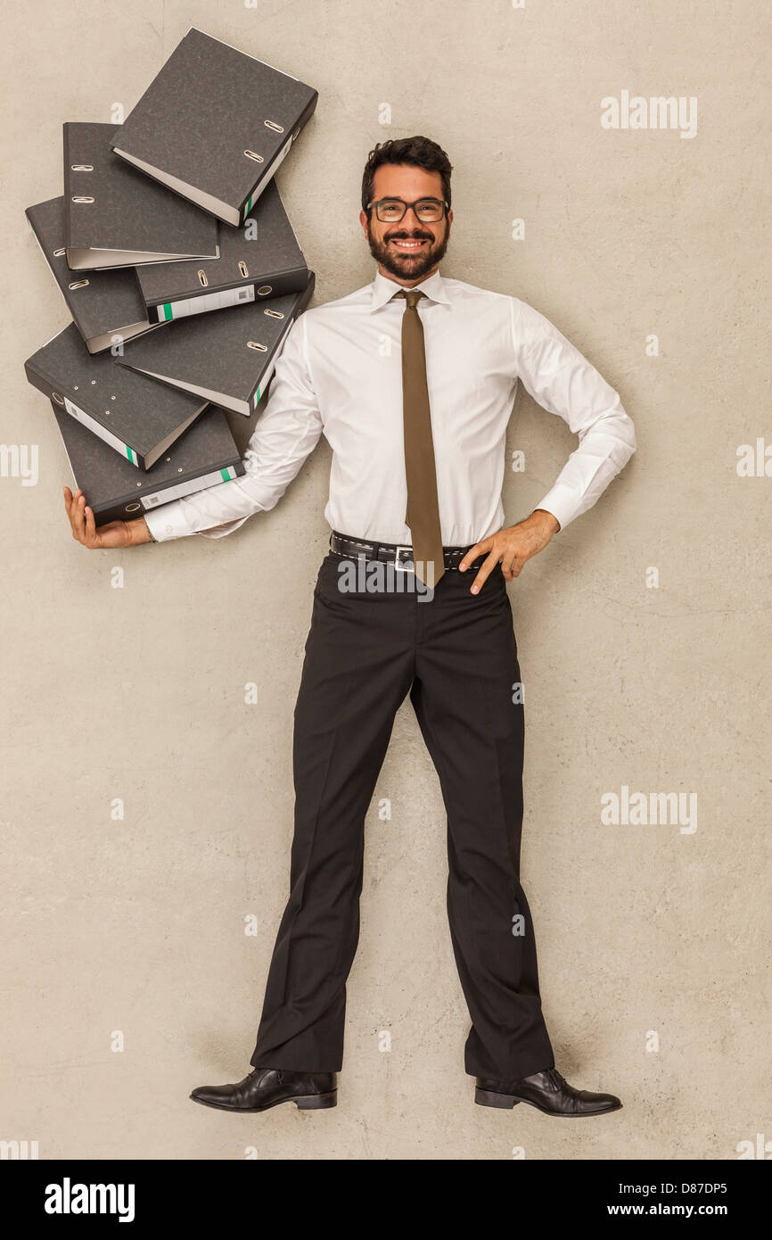 Businessman holding stack of files Stock Photo - Alamy