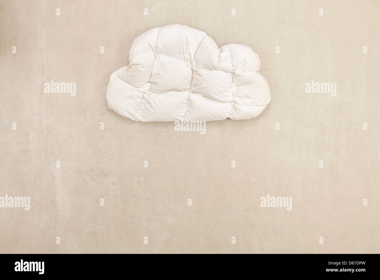 Cloud shape pillow on beige background Stock Photo - Alamy