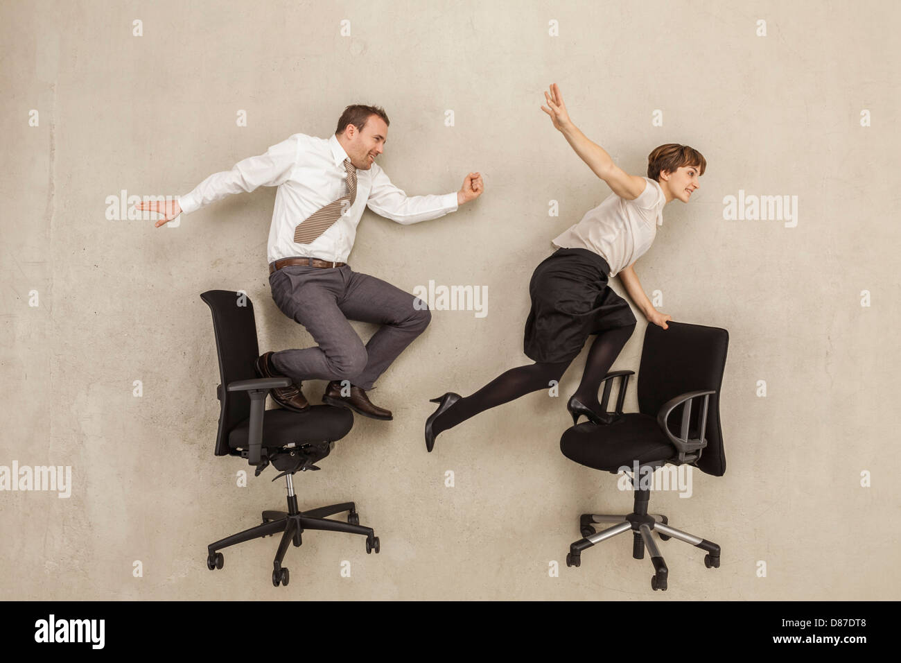 Business people skating on office chair Stock Photo - Alamy