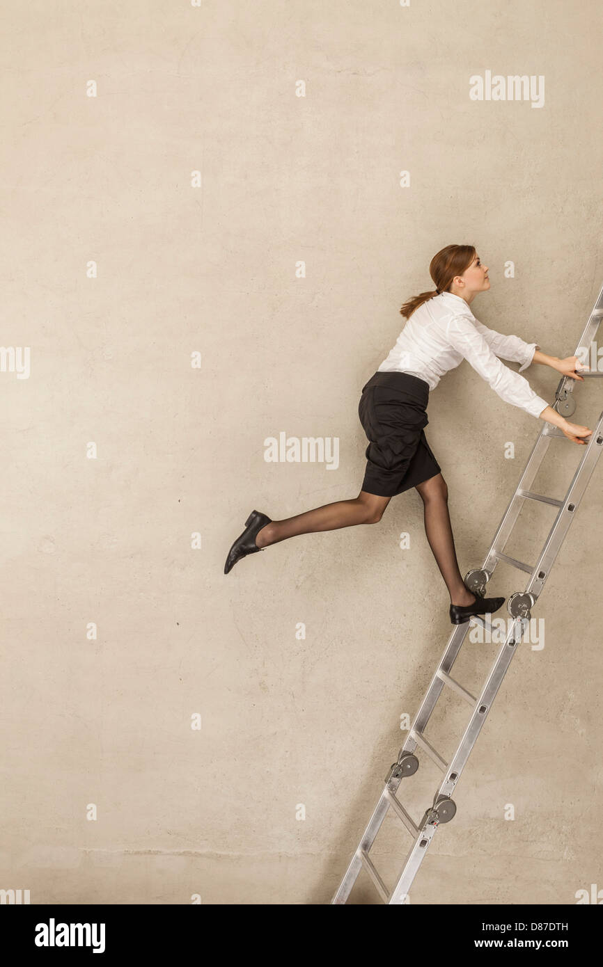 Businesswoman climbing ladder in office Stock Photo - Alamy Businesswoman climbing ladder in office Stock Photo - Alamy