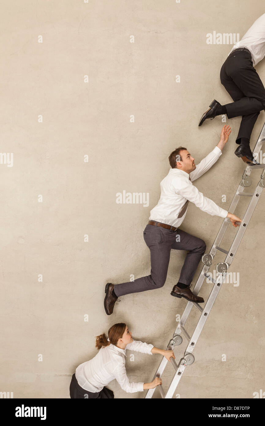 Business people climbing ladder in office Stock Photo - Alamy