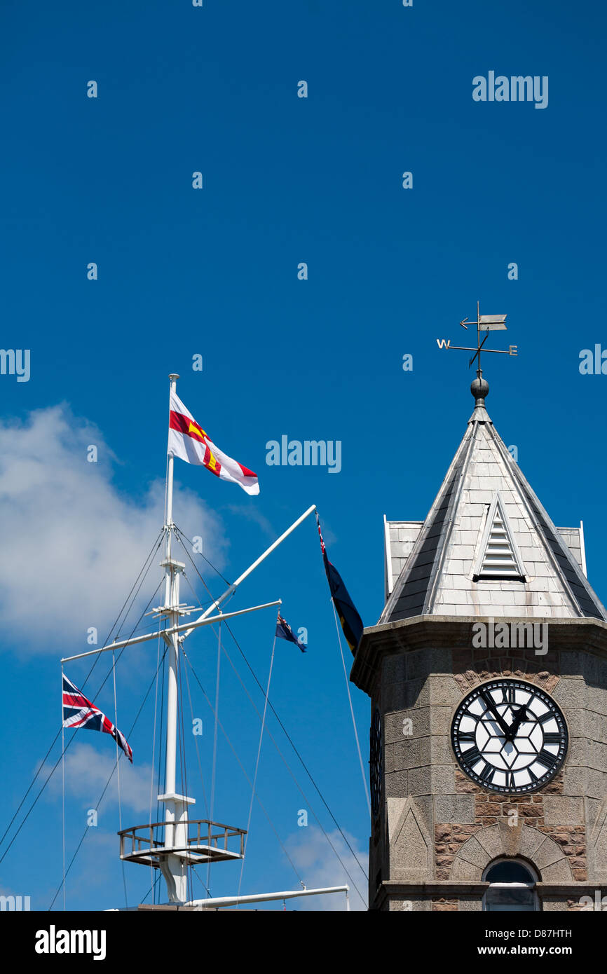 Guernsey flag on flag pole mast and modern seafront buildings ST PETERS ...