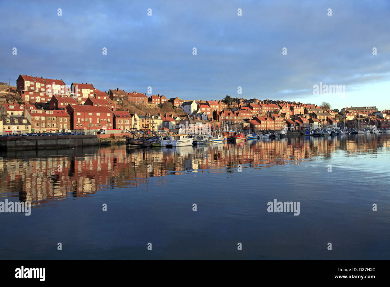 HOUSES ON BANK & FISHING BOATS IN HARBOUR AT SUNSET WHITBY NORTH ...