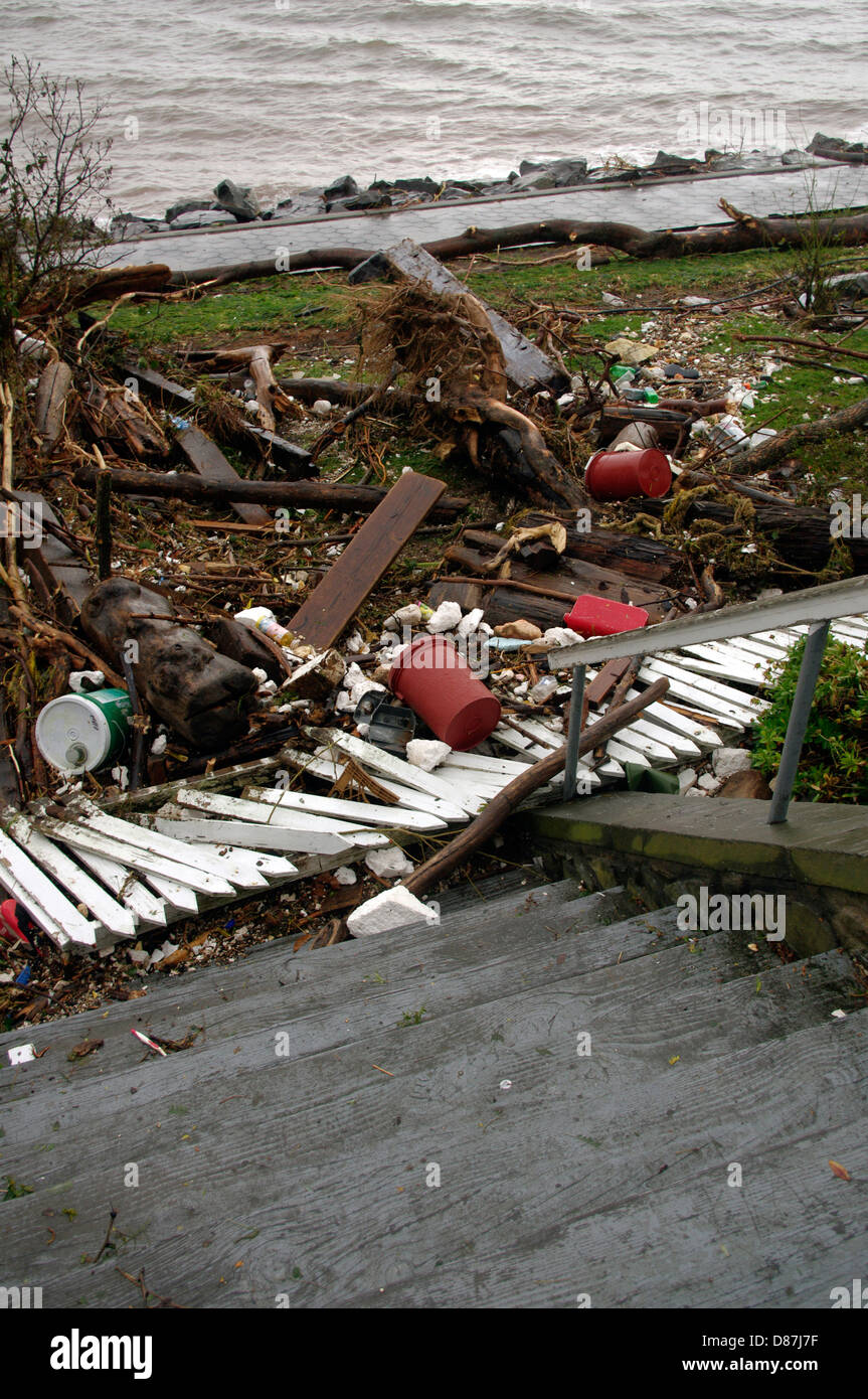 Destroyed picket fence, uprooted landscaping and flotsam washed over ...