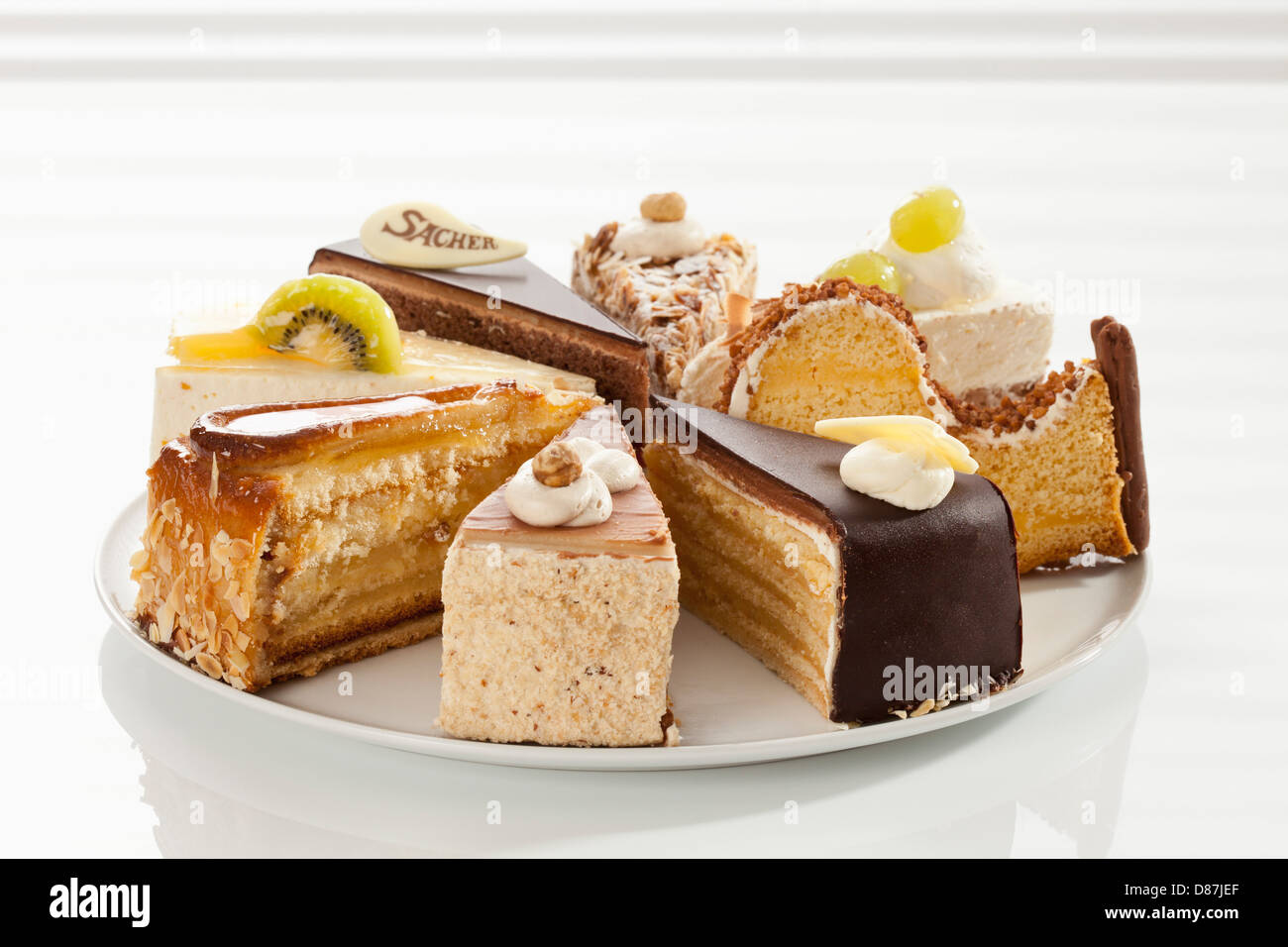 Variety of cakes on plate, close up Stock Photo - Alamy