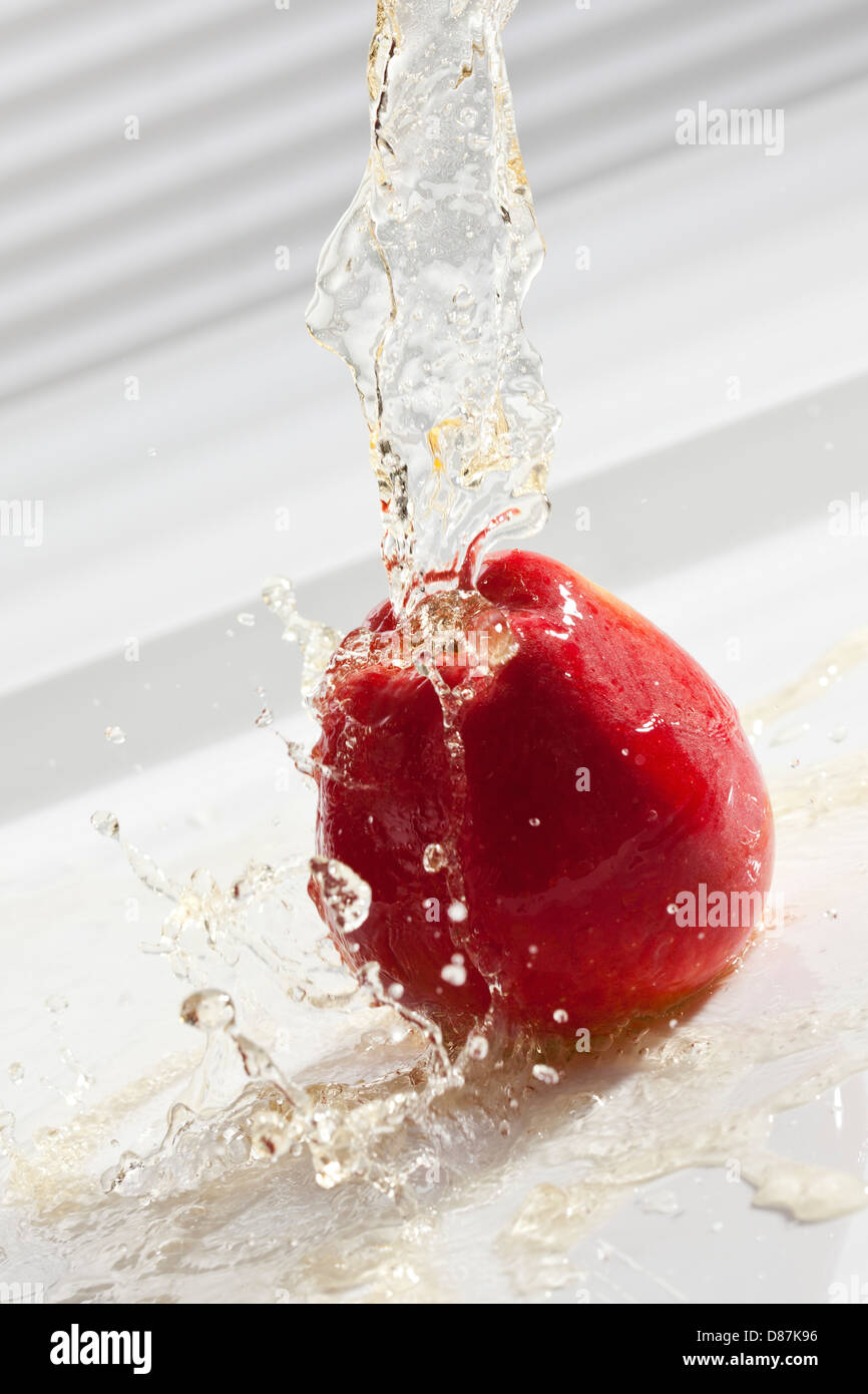 Apple juice with sparkling water pouring on apple Stock Photo - Alamy
