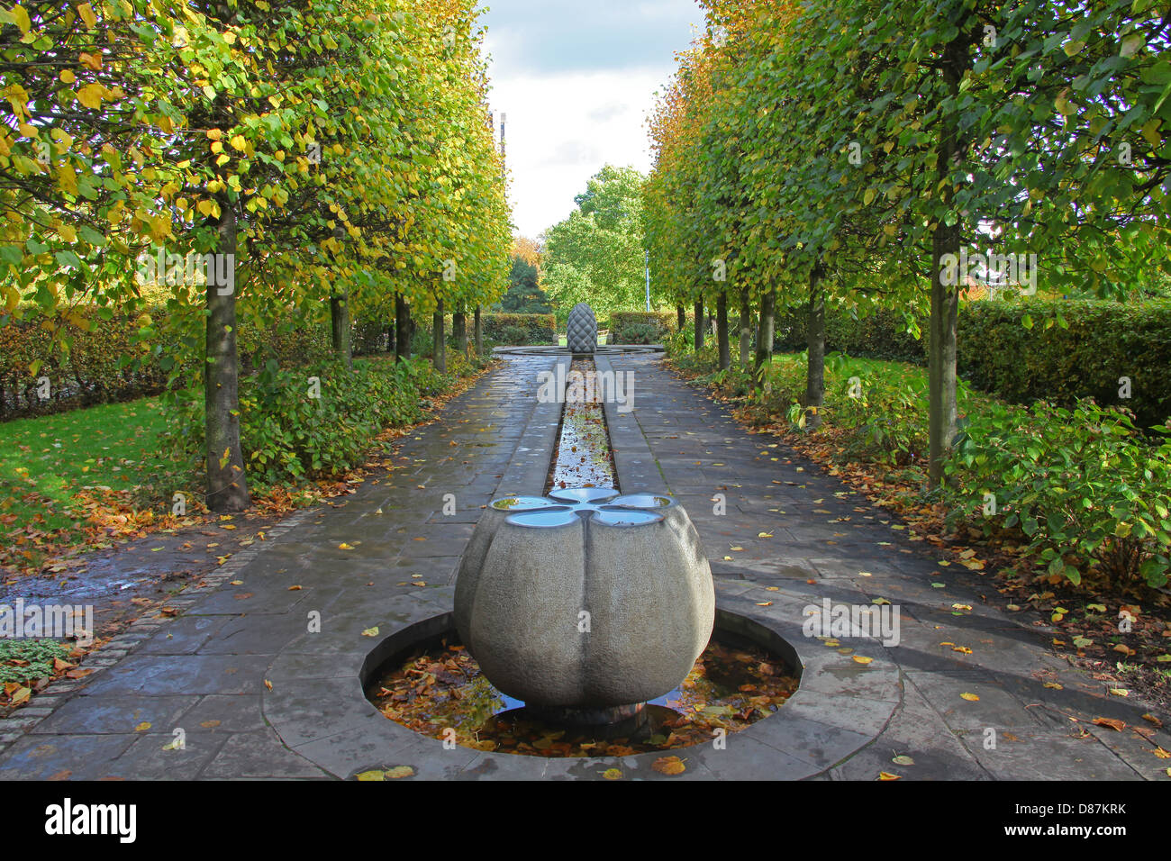 A memorial garden with a small but long water feature and decoration at ...