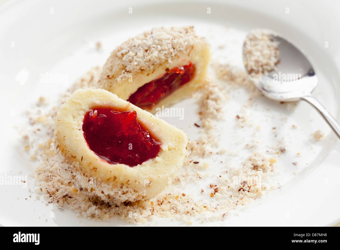 Curd cheese dumpling with strawberry filling and grounded hazelnut on ...