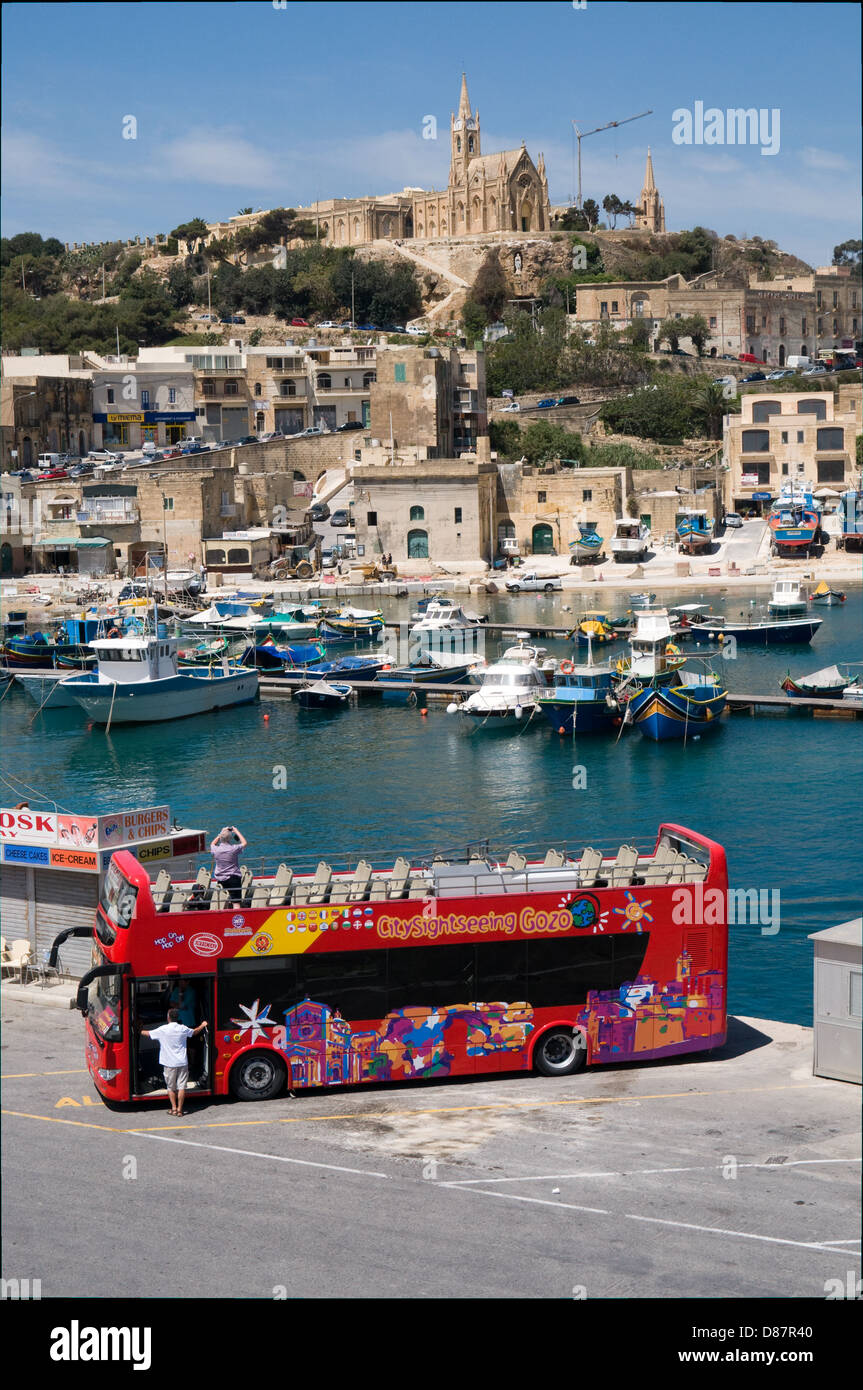 A tour bus waits for ferry passengers on the Maltese island of Gozo ...