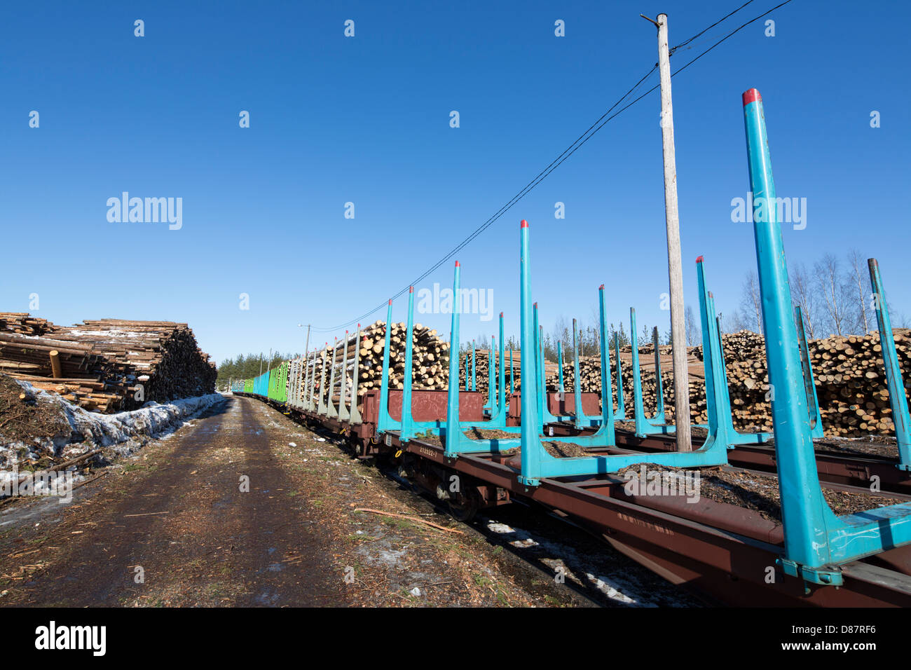 View of railroad depot for log transport and storage , log piles and ...