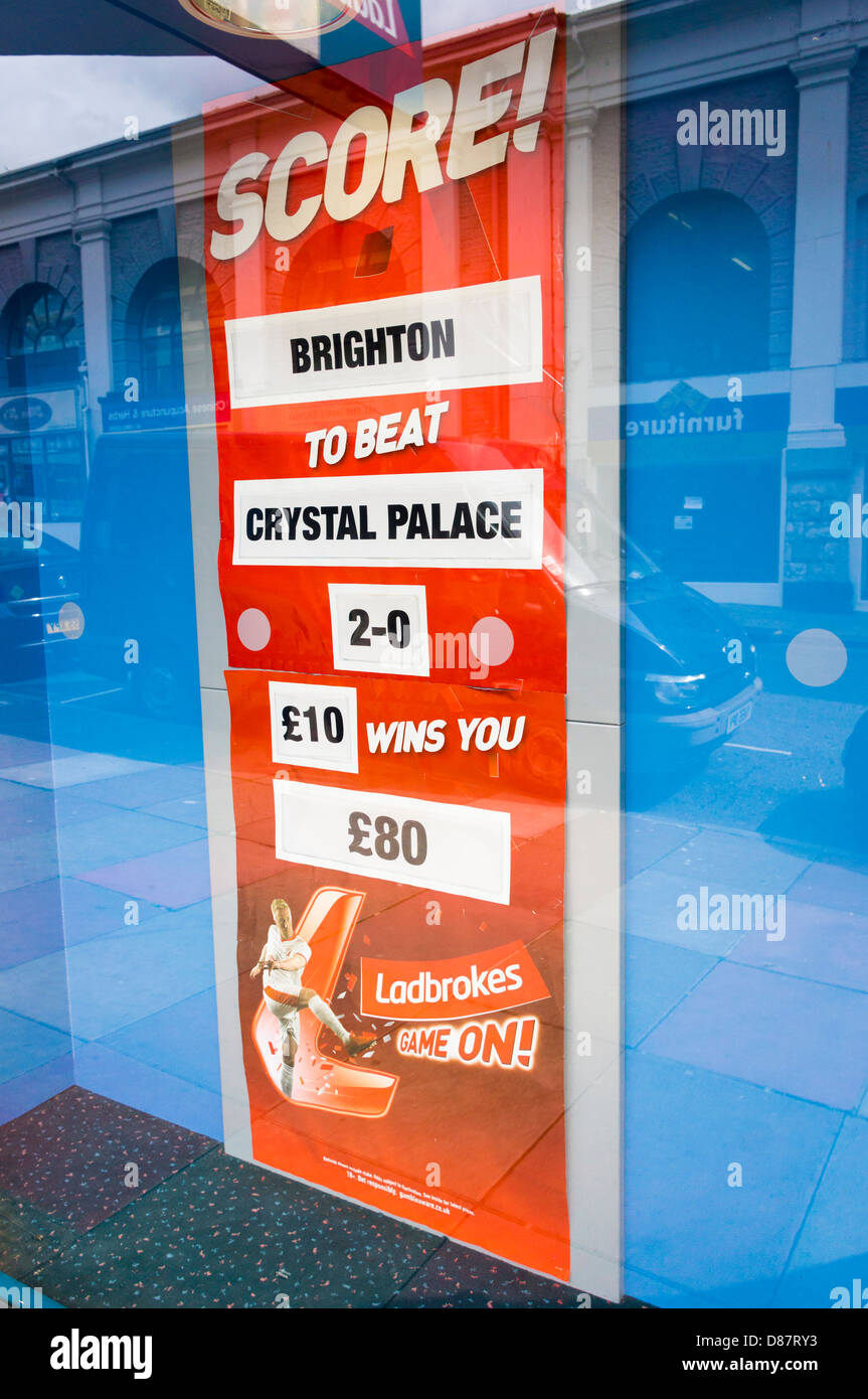 Football betting poster in a Ladbrokes betting shop window, UK Stock ...