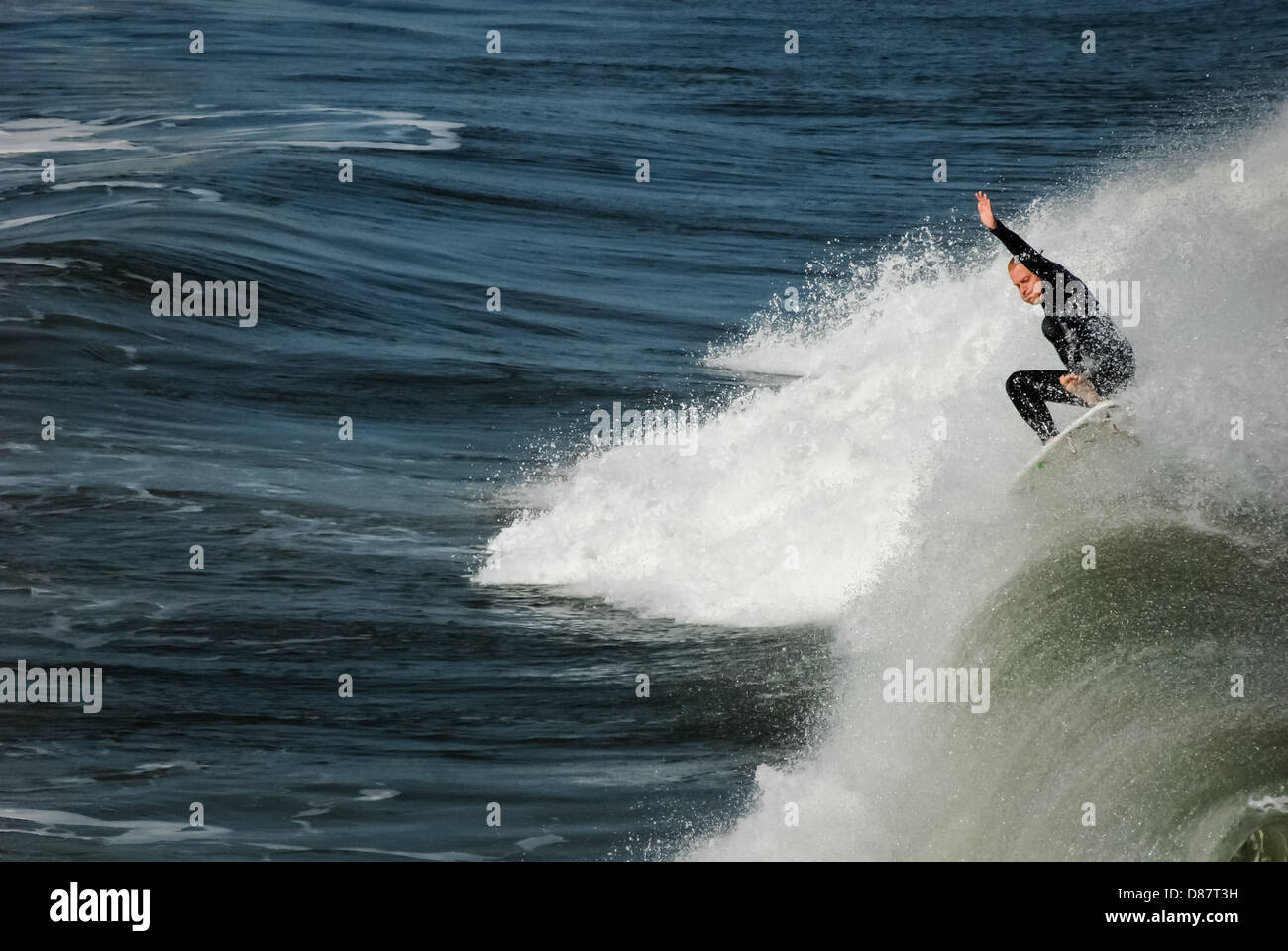 Surfer landing a dramatic aerial cutback on a wave at Jacksonville ...