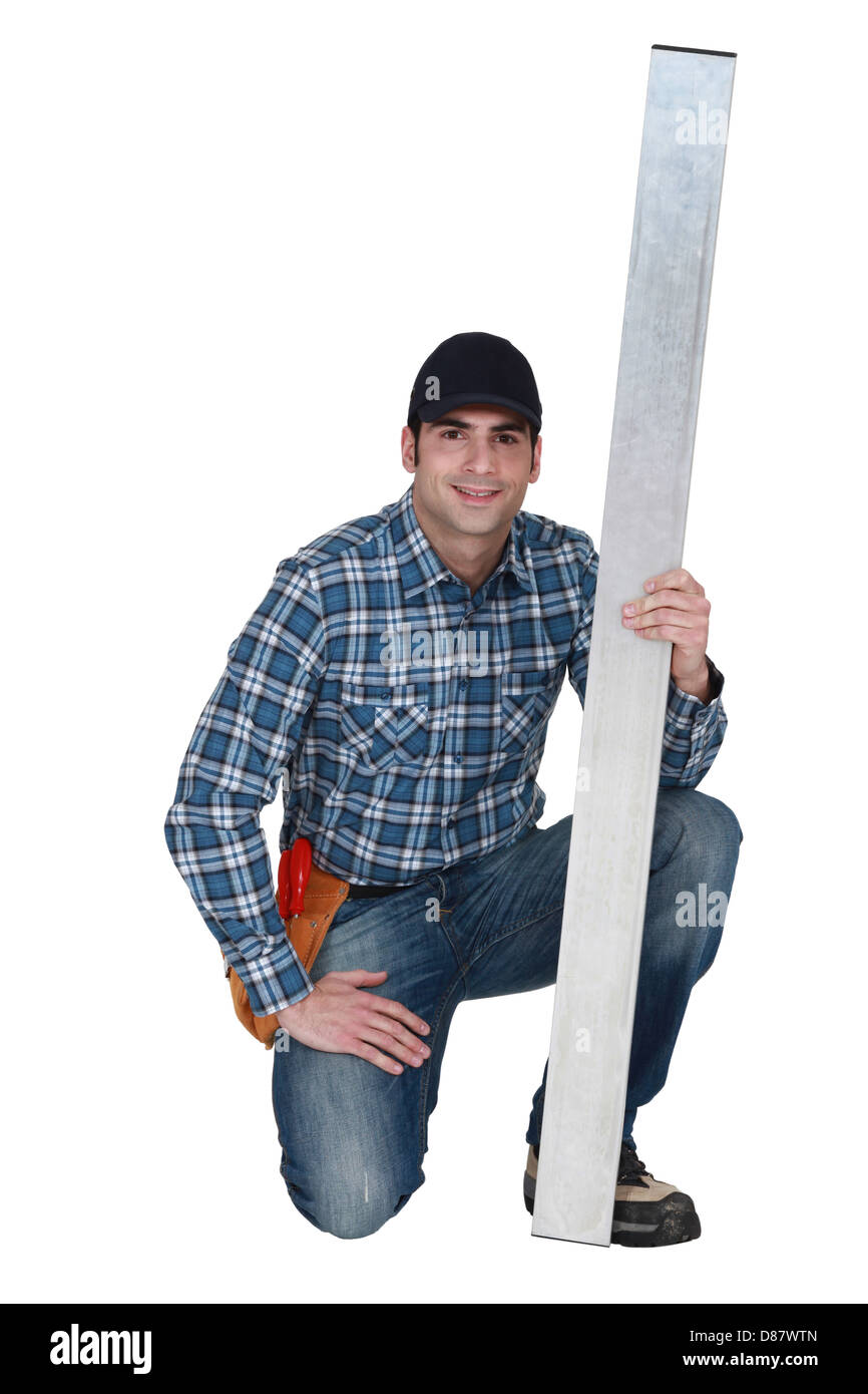 Man holding sheet of metal Stock Photo - Alamy