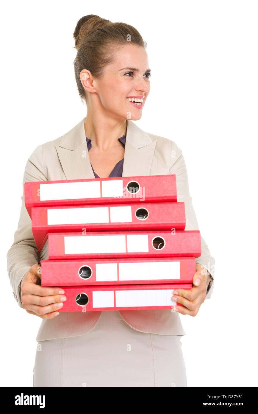 Smiling business woman holding stack of folders and looking on copy ...