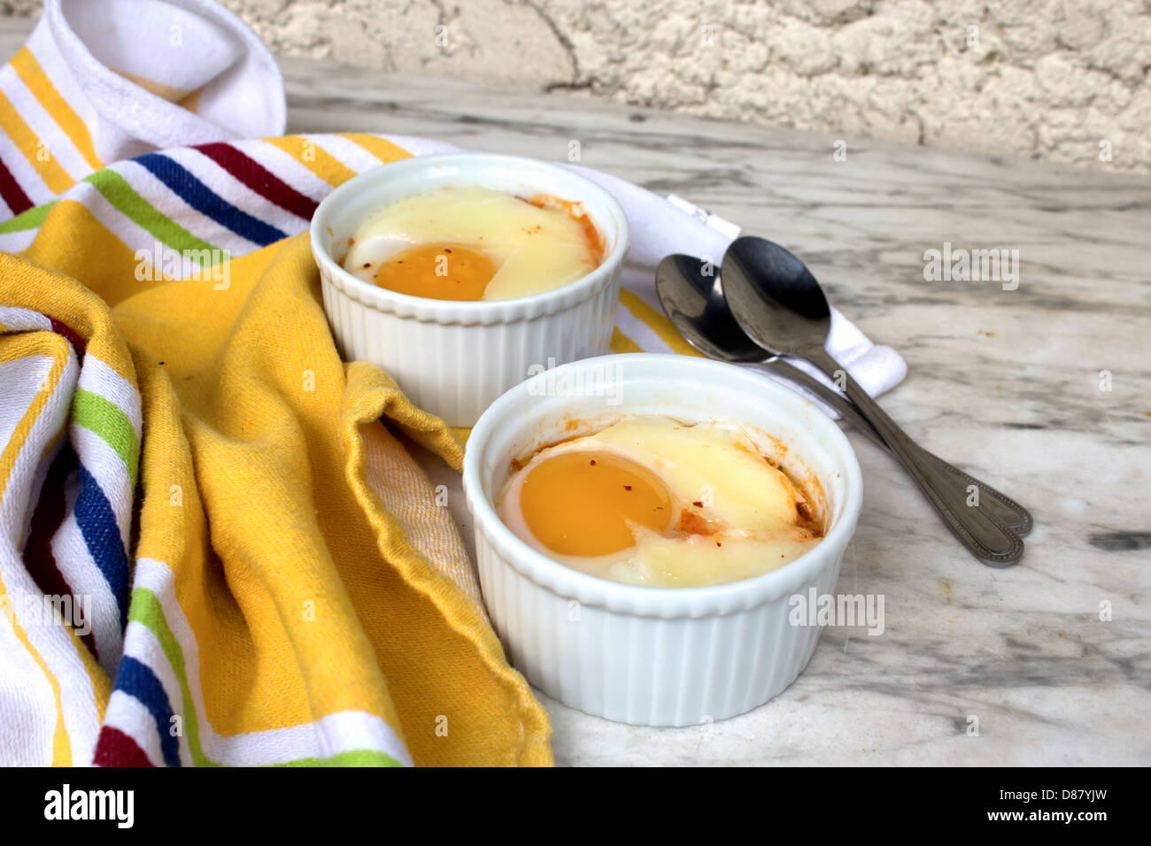 Egg in ramekin with tomato souce and chorizo cooked in boiled water ...