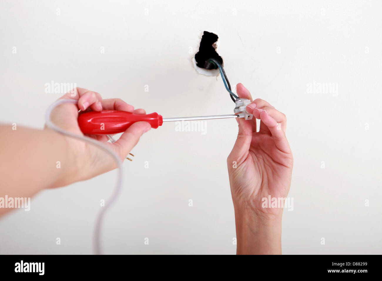 Man fixing ceiling lighting Stock Photo - Alamy