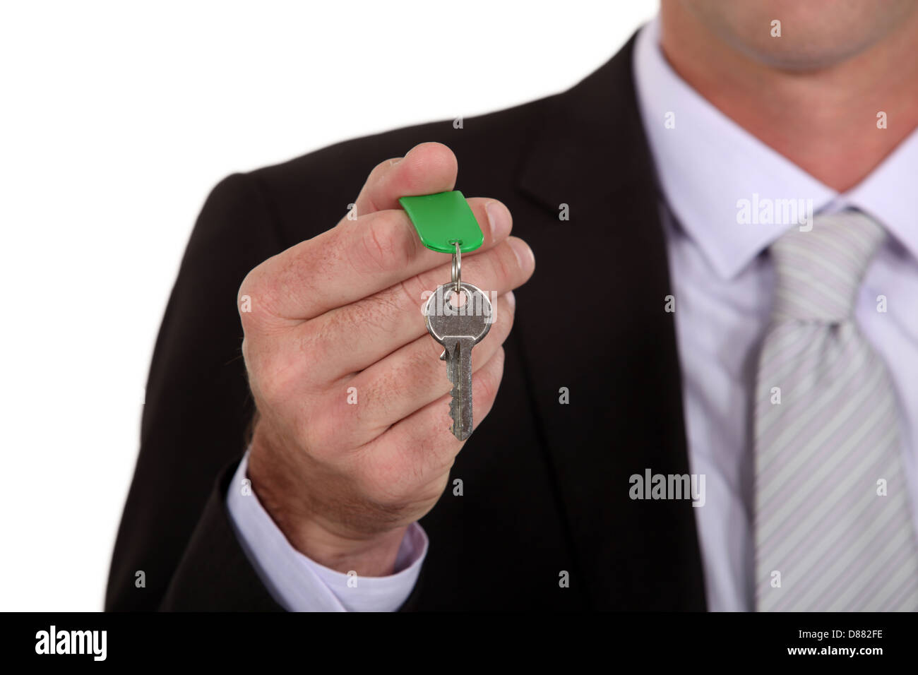 Businessman holding a key Stock Photo - Alamy