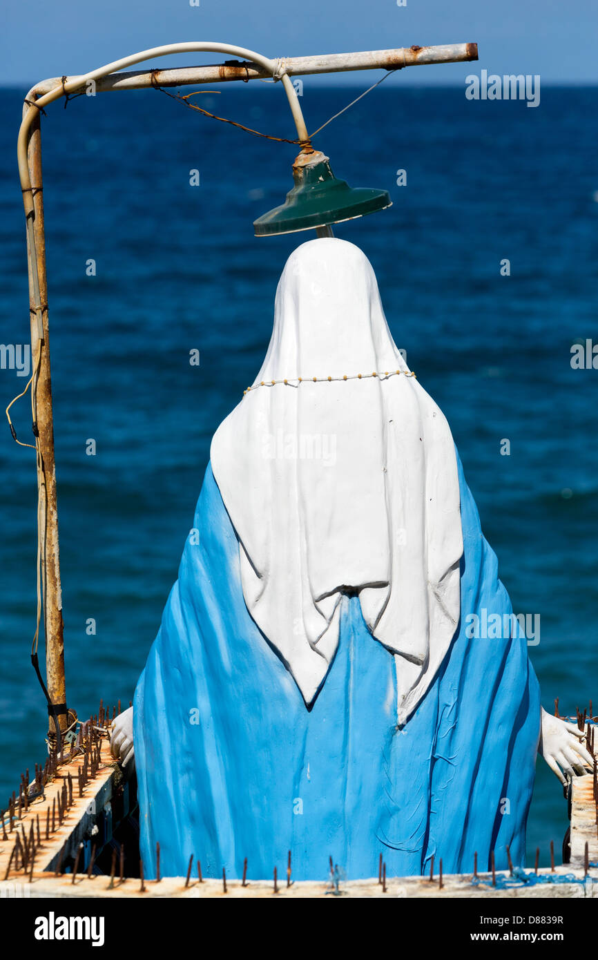 Virgin Maria Statue standing at the Coast on a Rock on Mindoro Island ...
