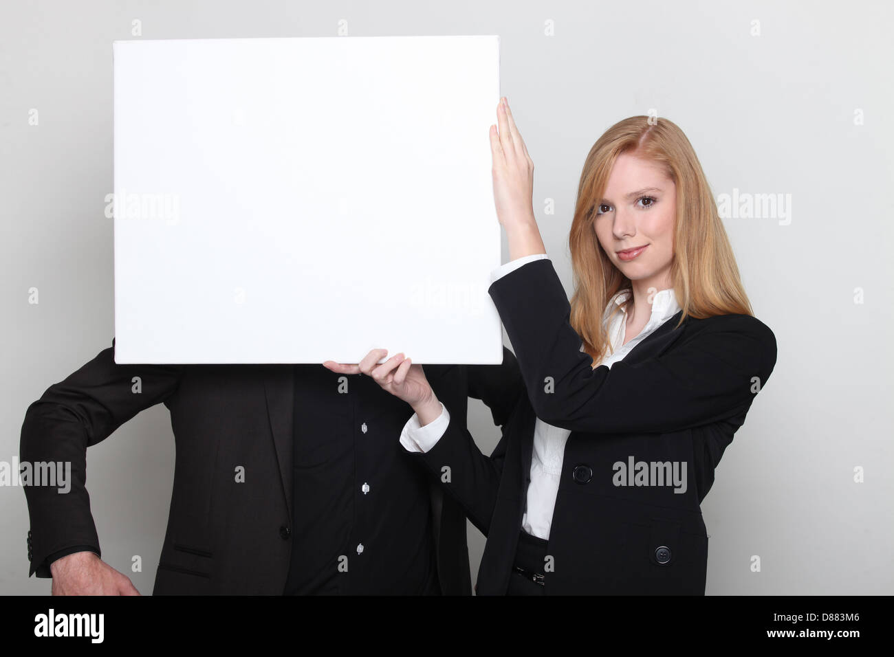 Covering man's face with poster Stock Photo - Alamy