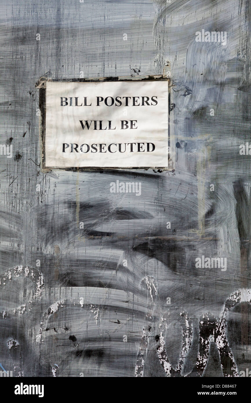 White-washed shop window with "Bill posters will be prosecuted" sign ...
