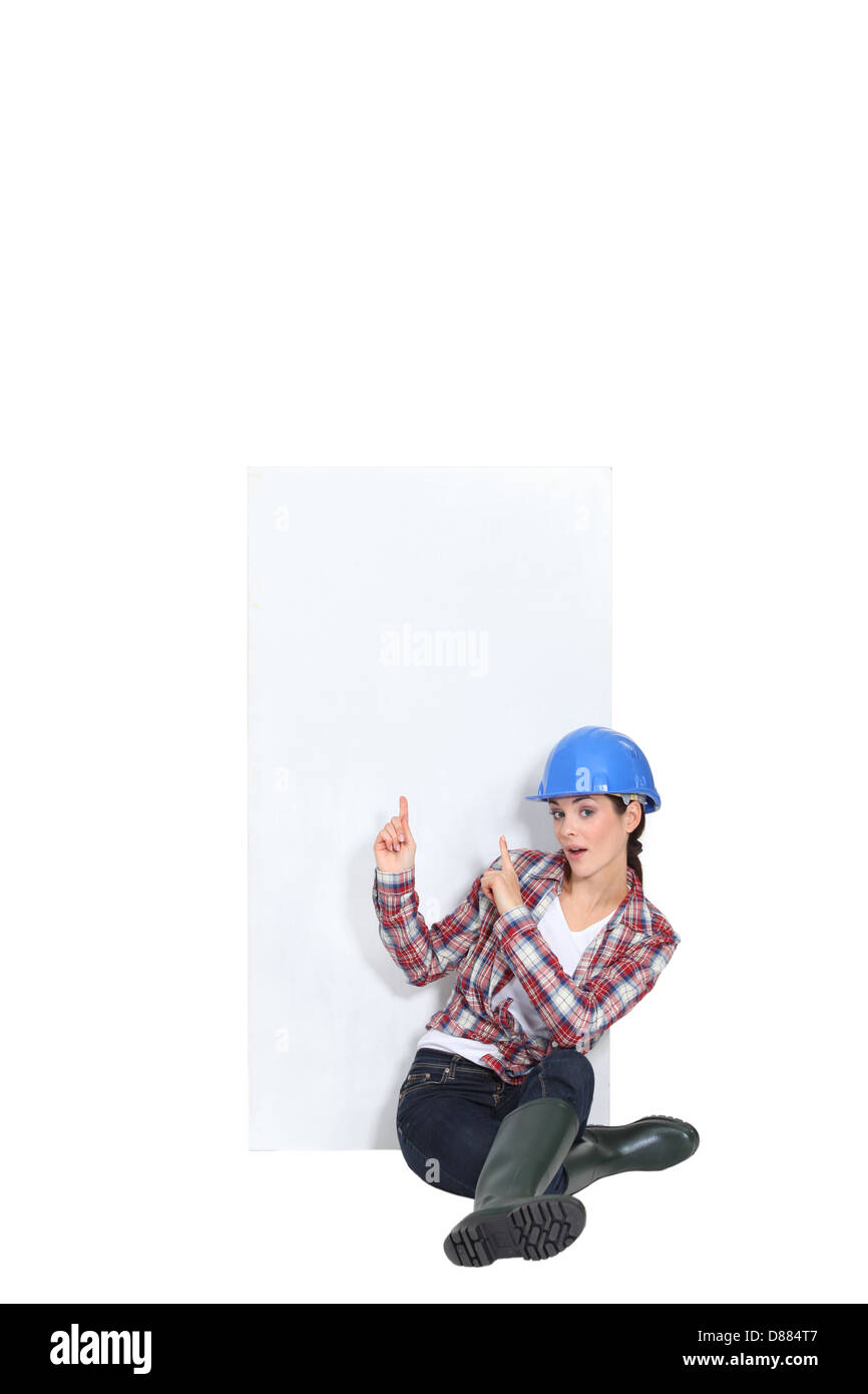 Female construction worker pointing at copyspace Stock Photo - Alamy