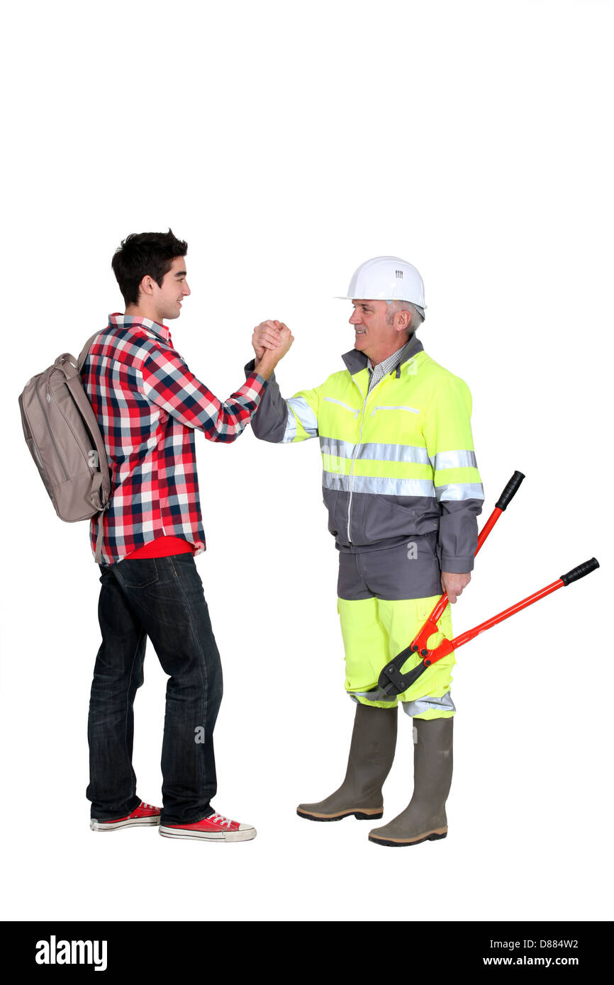 Experienced tradesman meeting his new apprentice Stock Photo - Alamy