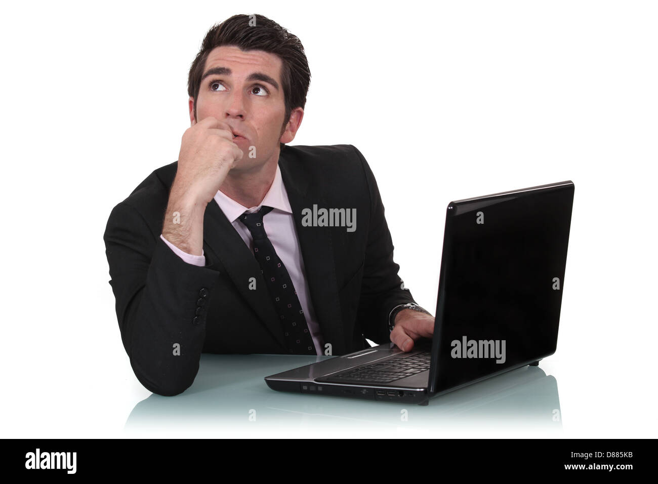 Daydreaming businessman sat at his desk Stock Photo - Alamy